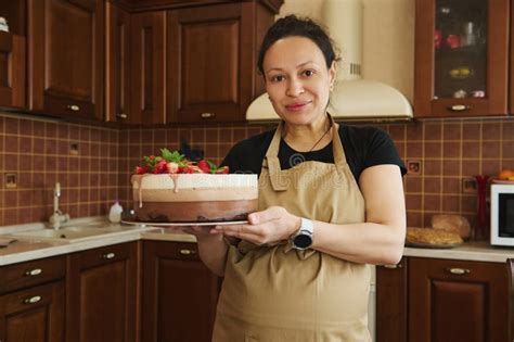 Multi Ethnic Pregnant Woman Confectioner Holding A Homemade Sweet
