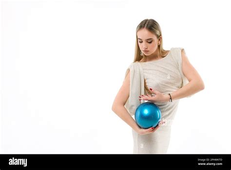 Girl Gymnast Dressed In An Evening Dress With A Ball On A White Background Stock Photo Alamy