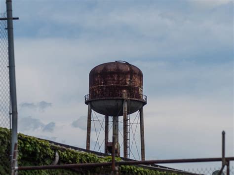 NEW SAVANNA Rusted Water Tower Cloudy Sky