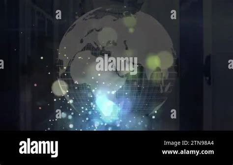 Animation Of Lens Flares Over Rotating Globe Against Server Room In