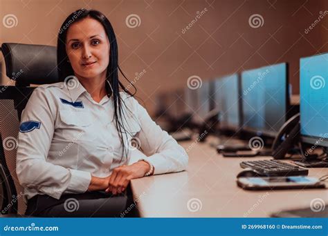 Female Security Operator Working In A Data System Control Room Offices