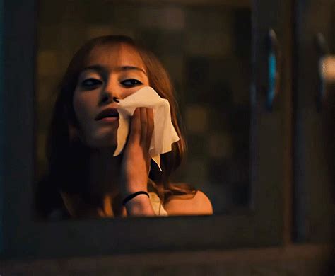 A Woman Holding A Napkin To Her Nose