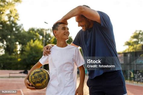 Proud Father Teasing His Son And Messing Up His Hair When Leaving The