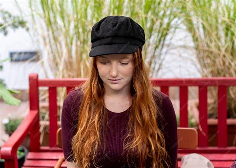 Premium Photo Pensive Redhead Girl Sitting Outdoors At The Garden