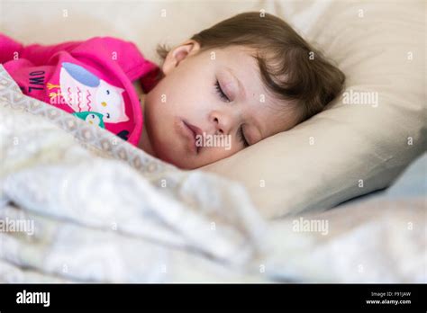 Baby Girl Sleeping In Her Parents Bed Stock Photo Alamy