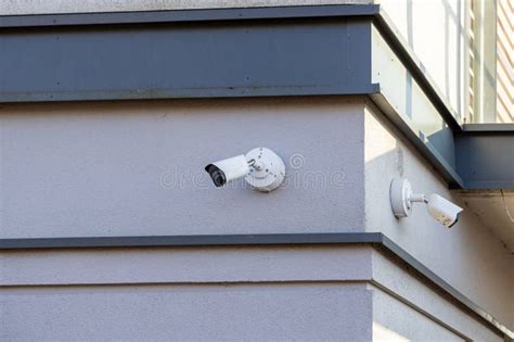 Security Cameras Mounted On Modern Building Facade For Surveillance And Monitoring Under