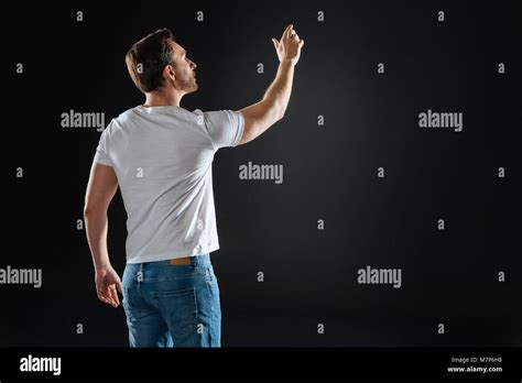 Handsome Interested Man Looking Up Lifting Right Hand Stock Photo Alamy
