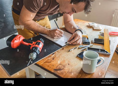 Man Making Draft Plan Using Pencil On The Table With Tools Stock Photo Alamy