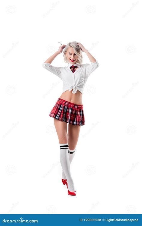 Playful Woman In Short Schoolgirl Plaid Skirt And Knee Socks With
