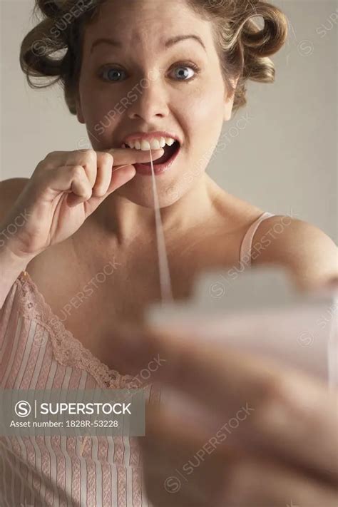 Woman Flossing Teeth Superstock
