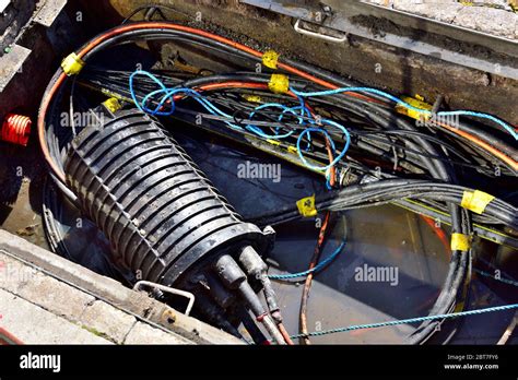 looking into telecom manhole in pavement with traditional copper wiring