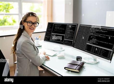 Programmer Woman Coding On Multiple Computer Screens Stock Photo Alamy