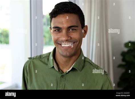 Young Biracial Man Smiles Warmly In A Home Setting His Cheerful