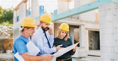 Architect Civil Engineer And Worker Looking At Plans And Blueprints