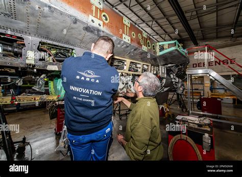 Illustration Picture Shows A Technician Working On An F16 Fighter Jet
