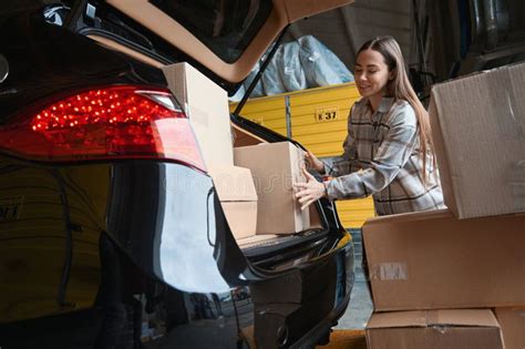 Smiling Grown Woman Packing A Box Into The Trunk Stock Photo Image Of Shipping Satisfied