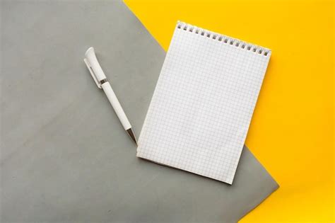 Premium Photo Open Notebook And Pen On Gray And Yellow Background