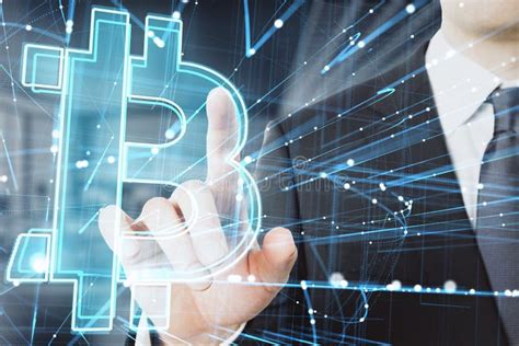 Close Up Of Businessman Hand Pointing At Abstract Glowing Holographic Bitcoin Icon On Blurry