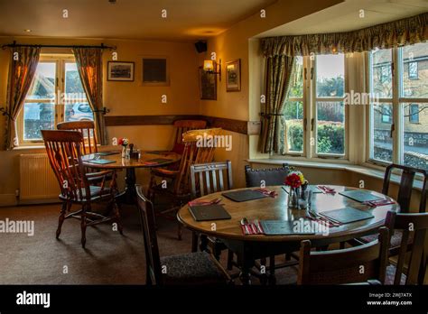 The Interior Of A Public House Which Is Warm And Inviting With Tables