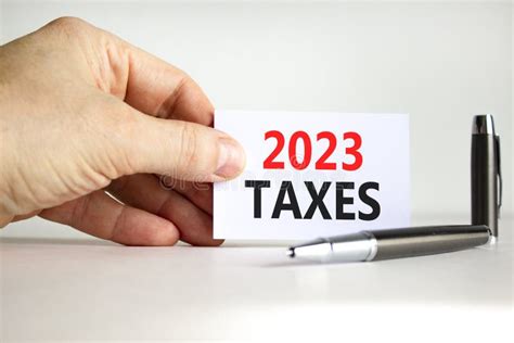 2023 Taxes New Year Symbol White Paper With Words 2023 Taxes Businessman Hand Metallic Pen