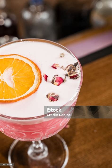 핑크 클로버 클럽 알코올 칵테일과 장미 장식이 바에서 클로즈업 바텐더는 달걀 흰자 레몬 드라이 베르무트 진을 섞어 클로버 클럽 칵테일을 준비합니다 0명에 대한 스톡 사진 및