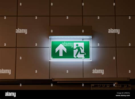 Emergency Exit Sign Glowing In The Dark Stock Photo Alamy