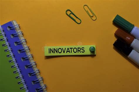 Innovators Write On Sticky Notes Isolated On Orange Table Background