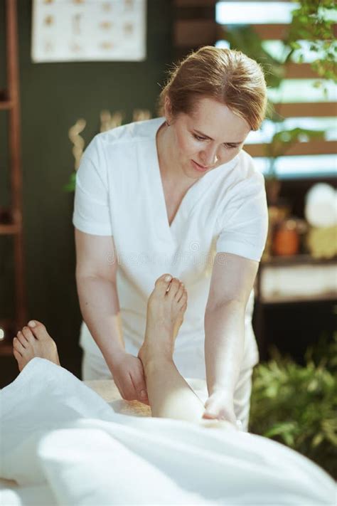 Medical Massage Therapist In Spa Salon Massaging Clients Leg Stock