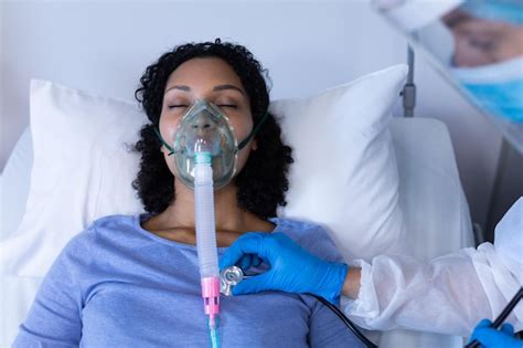 Premium Photo Caucasian Doctor In Ppe Suit Examining With Stethoscope Female Patient With