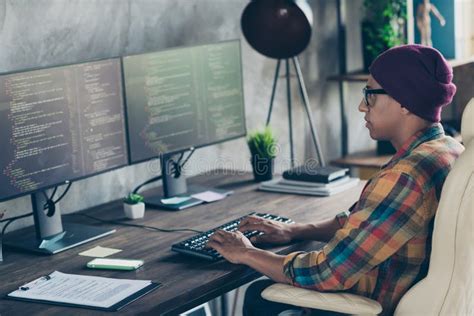 Photo Of Serious Confident Guy Dressed Eyewear Hat Typing Code Modern Device Indoors Workstation