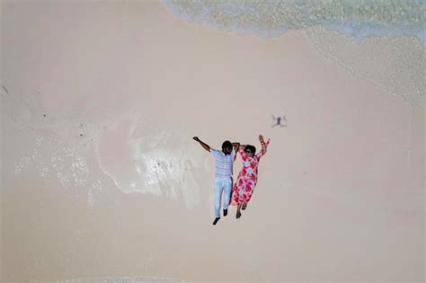 Premium Photo Couple Lying On Beach Drone Shot