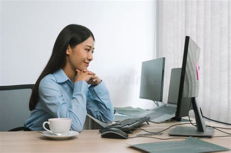 Asian Woman Software Developers Sitting In Front Of Computers Looking At Computer Codes On The