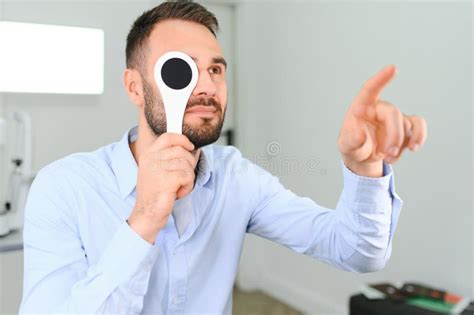 Test Of Sight Man Is Checking His Vision Indoors In The Clinic Stock Image Image Of Help