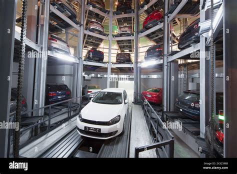 The Car On Lift In Premises For Storage Cars In Center At Night The