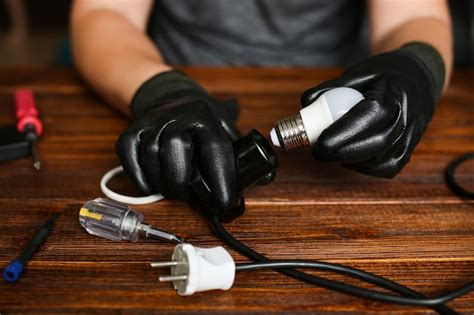 Premium Photo A Professional Electrician Changing Bulb Man Screwing A New Lightbulb Into Ceiling