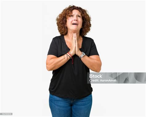 아름 다운 중간 어른 얼굴 매우 감정적이 고 걱정에 희망 식 함께 손으로 기도하 고 구걸 격리 된 배경 위에 고위 여자 용 서에 대 한 요구 종교 개념입니다 갈색 머리에