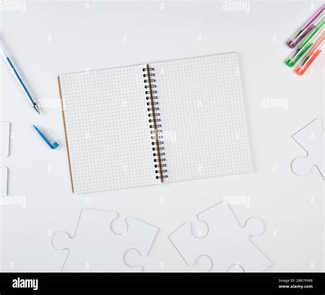 Open Notebook In A Cell And On A White Background Next To Large Blank