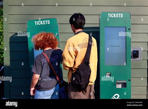 People Using A Credit Card Only Automated Ticket Machine With One