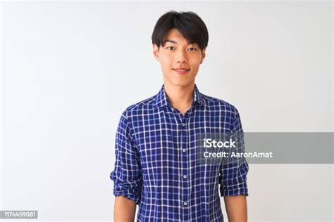 얼굴에 행복하고 시원한 미소와 고립 된 흰색 배경 위에 서 캐주얼 블루 셔츠를 입고 젊은 중국 남자 운이 좋은 사람 긍정적인 감정 표현에 대한 스톡 사진 및 기타 이미지