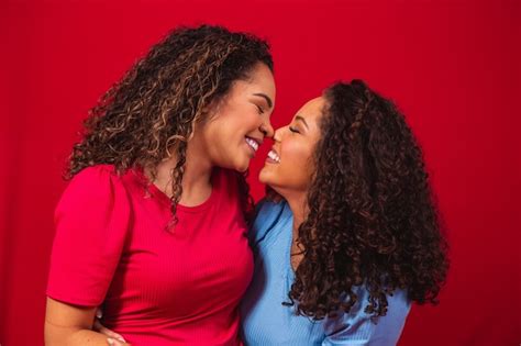 Premium Photo Portrait Of Young Afro Women Lesbian Couple On Red