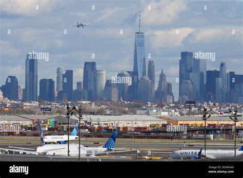 The New York City Skyline Is Seen Behind A Plane Approaching Newark