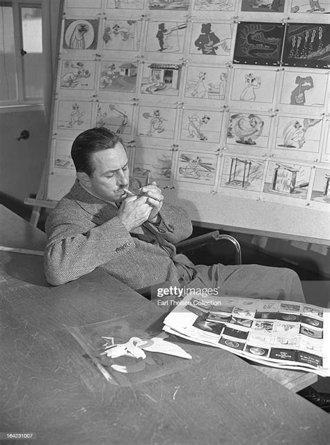 Walt Disney Lights A Cigarette While Seated Next To A Storyboard For News Photo Getty Images