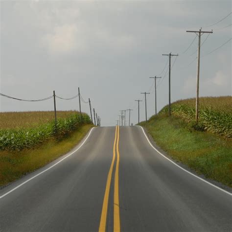 Premium Photo Road Passing Through Field