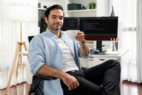 Profile It Looking Camera Holding Coffee Cup Against Coding On Pc