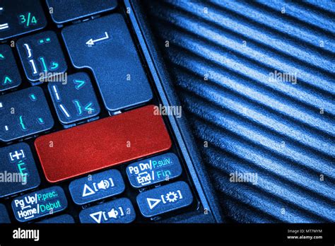 close up of computer laptop keyboard with a blank red button for any