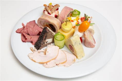 Closeup Of A Plate With Different Types Of Cheese And Ham Stock Photo