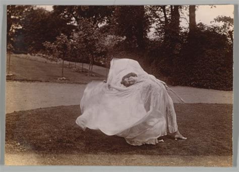 [loie Fuller Full Length Portrait Standing Facing Front Raising Her Very Long Gown In Shape