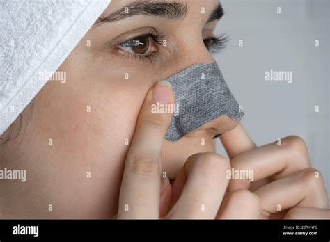 A Woman Sticks A Cleansing Strip On Her Nose Black Dots On The Nose Girl Without Makeup In The
