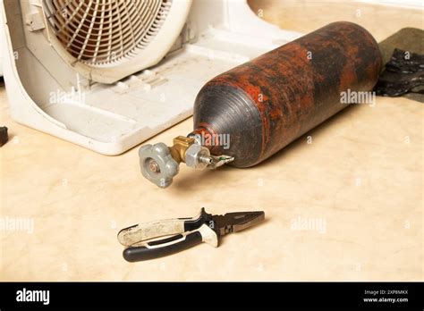 Freon Cylinder And Disassembled Air Conditioner On The Floor In The