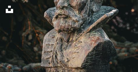 A Statue Of A Man Holding A Pipe Photo Free Woman Image On Unsplash